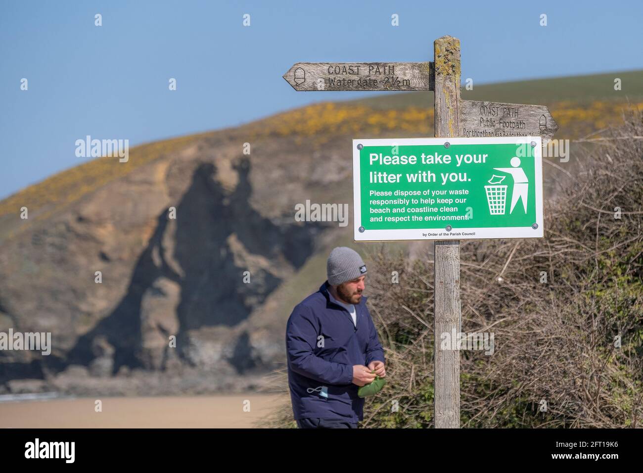 A litter sign and coast path direction sign at Mawgan Porth in Cornwall ...