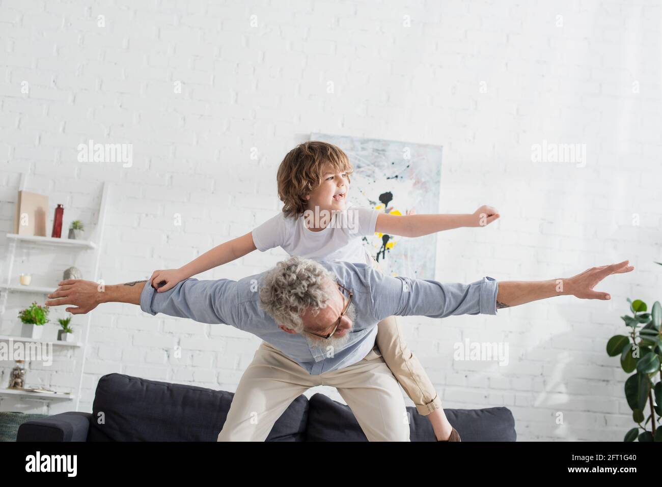 Mature man playing with kid at home Stock Photo - Alamy
