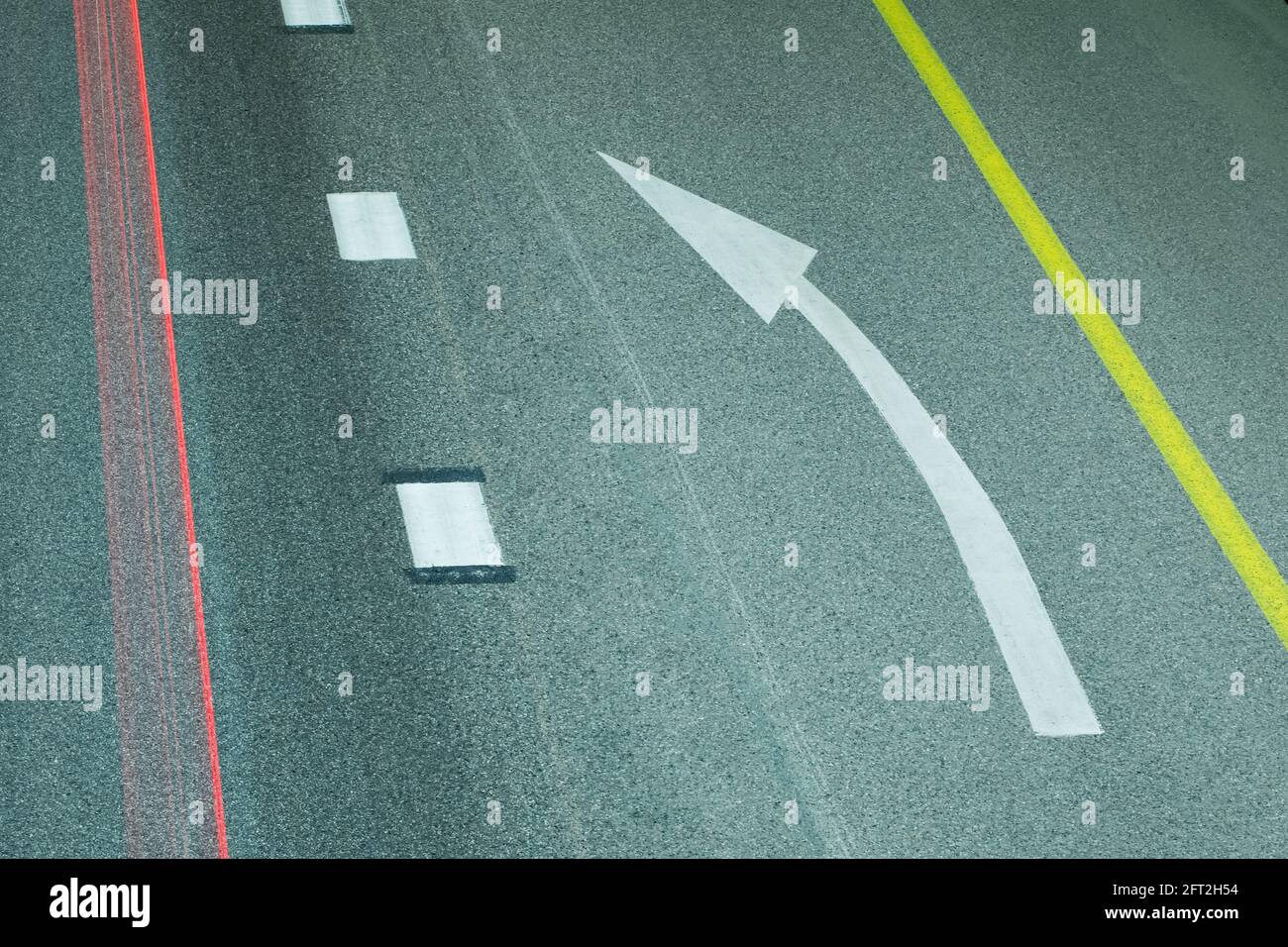 The white arrow turns left on the road between the solid and broken ...