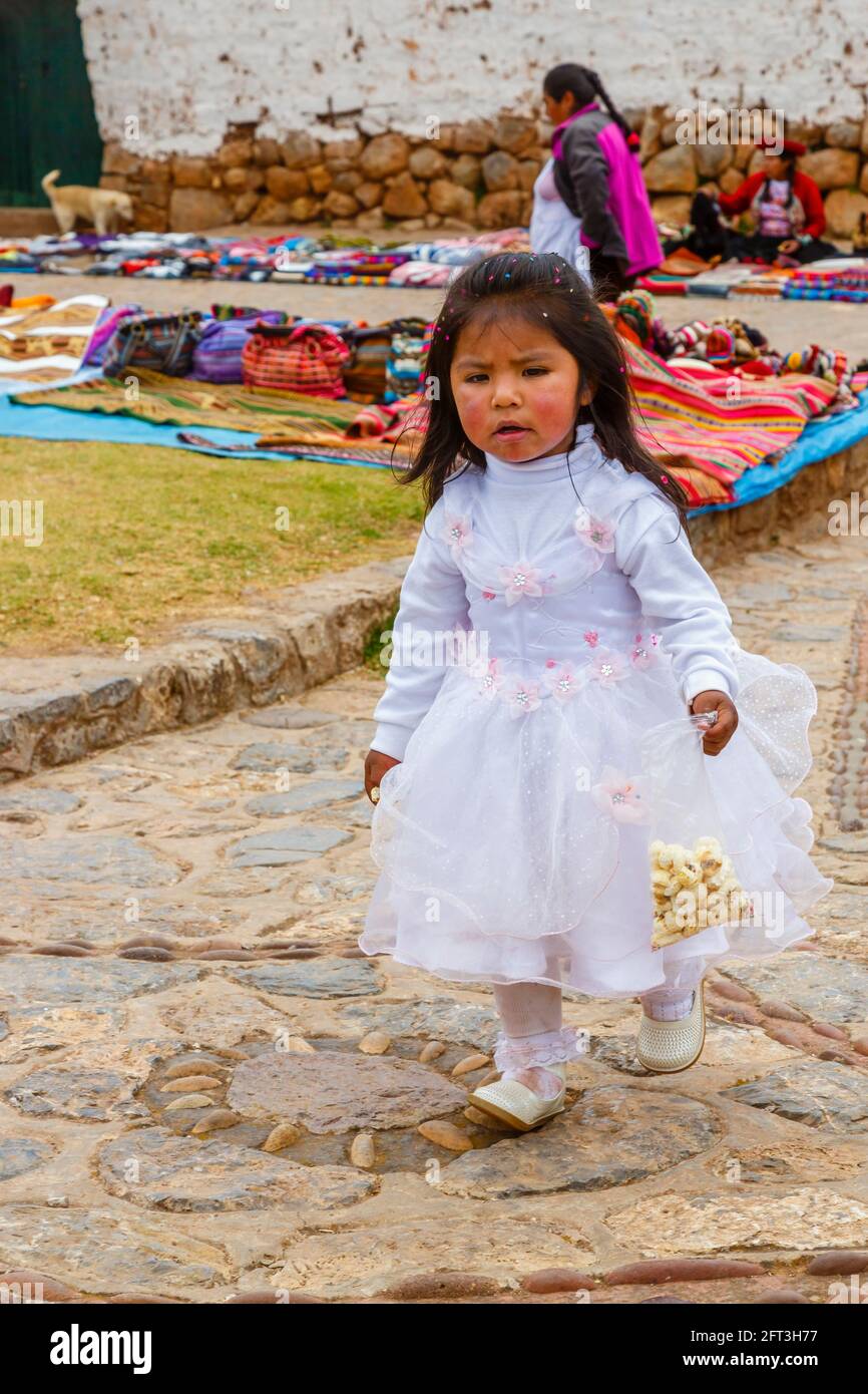 Cute young Quechua bridesmaid in a frilly white dress at a wedding in ...