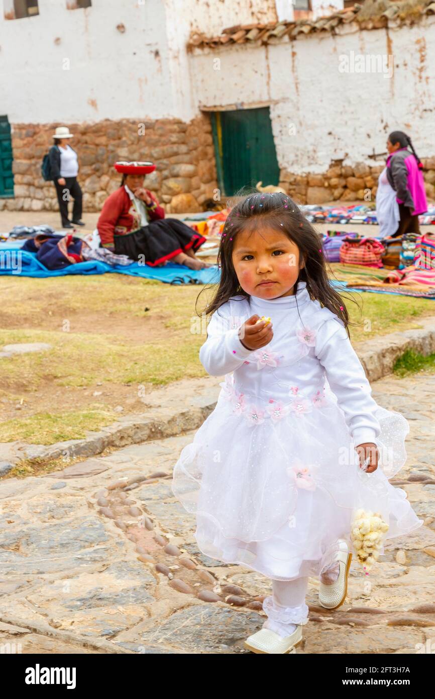 Cute young Quechua bridesmaid in a frilly white dress at a wedding in ...