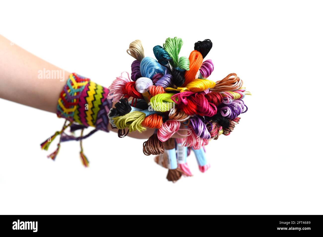 Many embroidery thread for friendship bracelets in hand. Female hand ...