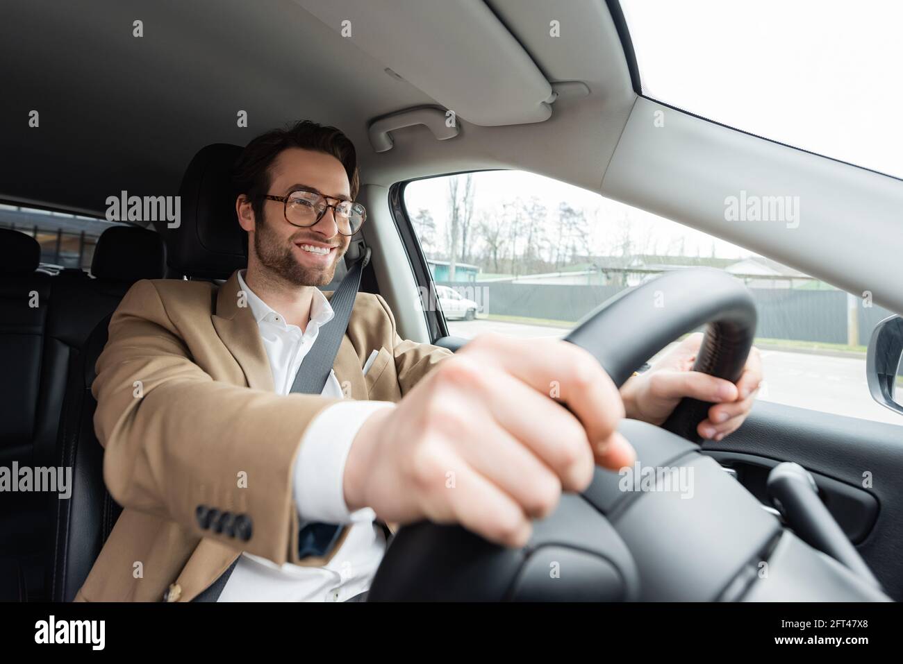 smiling bearded man in glasses driving modern car Stock Photo - Alamy