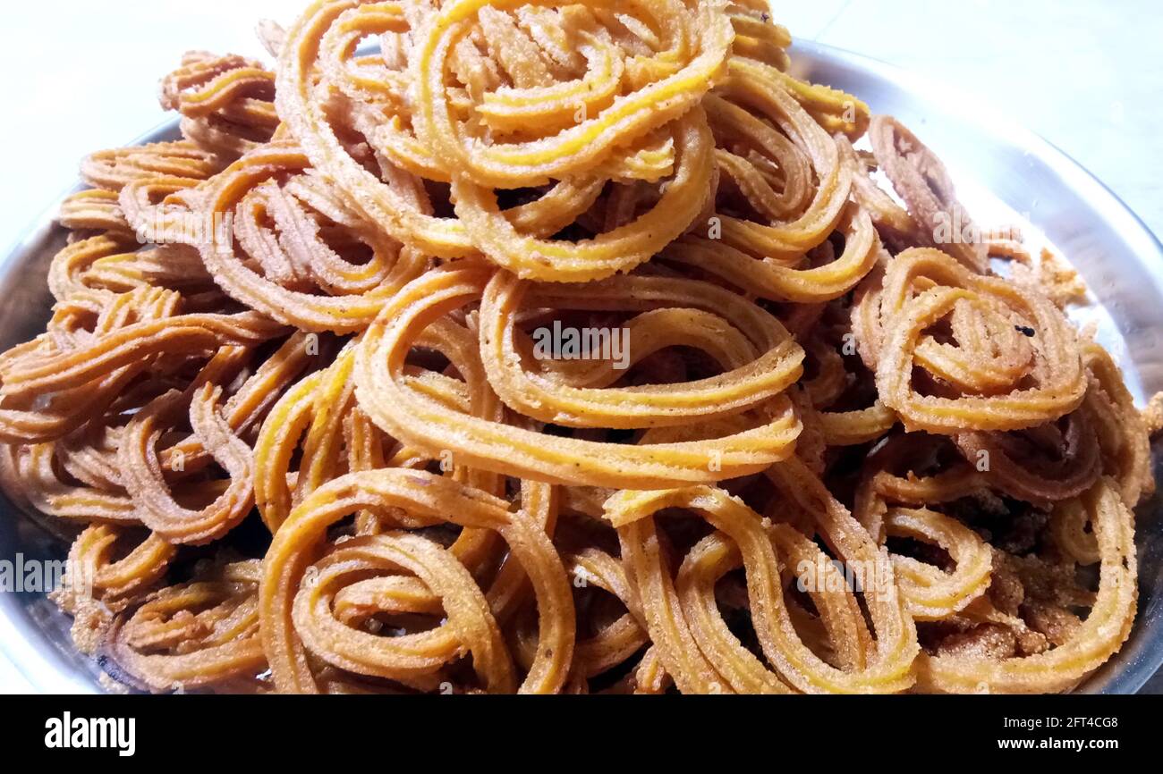 Indian Traditional Snack Chakli, a spiral shaped crisp deep fried snack ...
