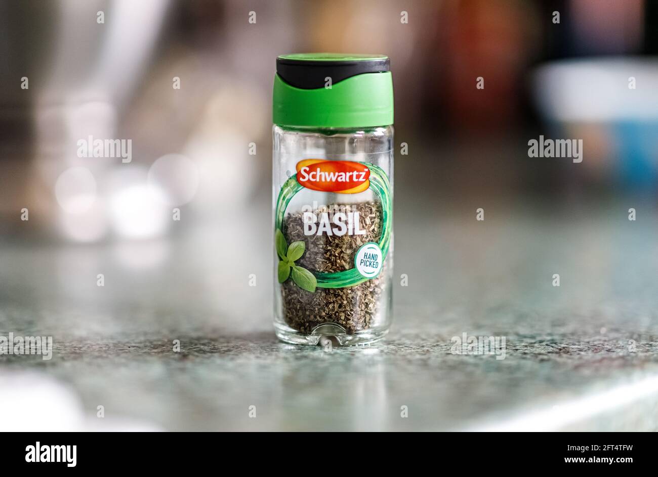 Half full glass/plastic jar of dried basil in a UK kitchen Stock Photo ...