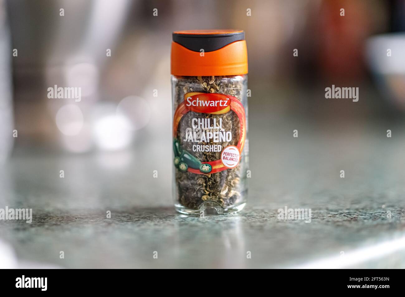 Full glass/plastic jar of crushed Chilli Jalapeño in a UK kitchen Stock ...