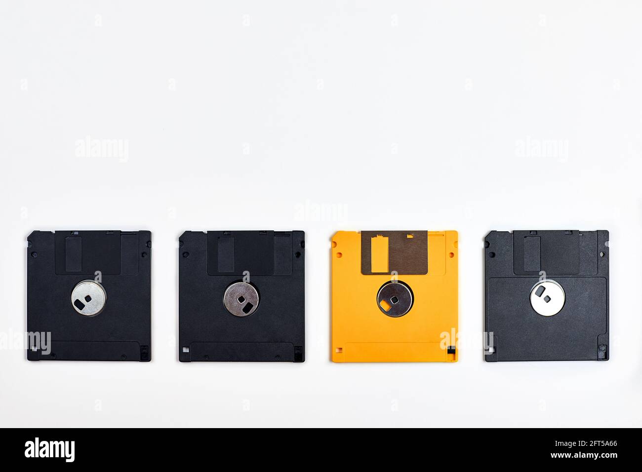 Several floppy disks of different colors on a white background ...