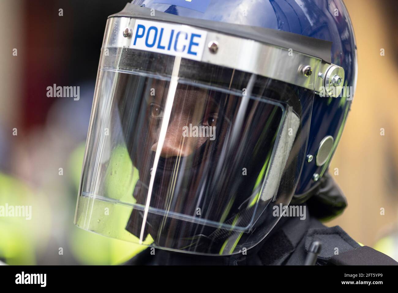 Headshot of a black police officer in riot helmet and face mask, 'Free ...