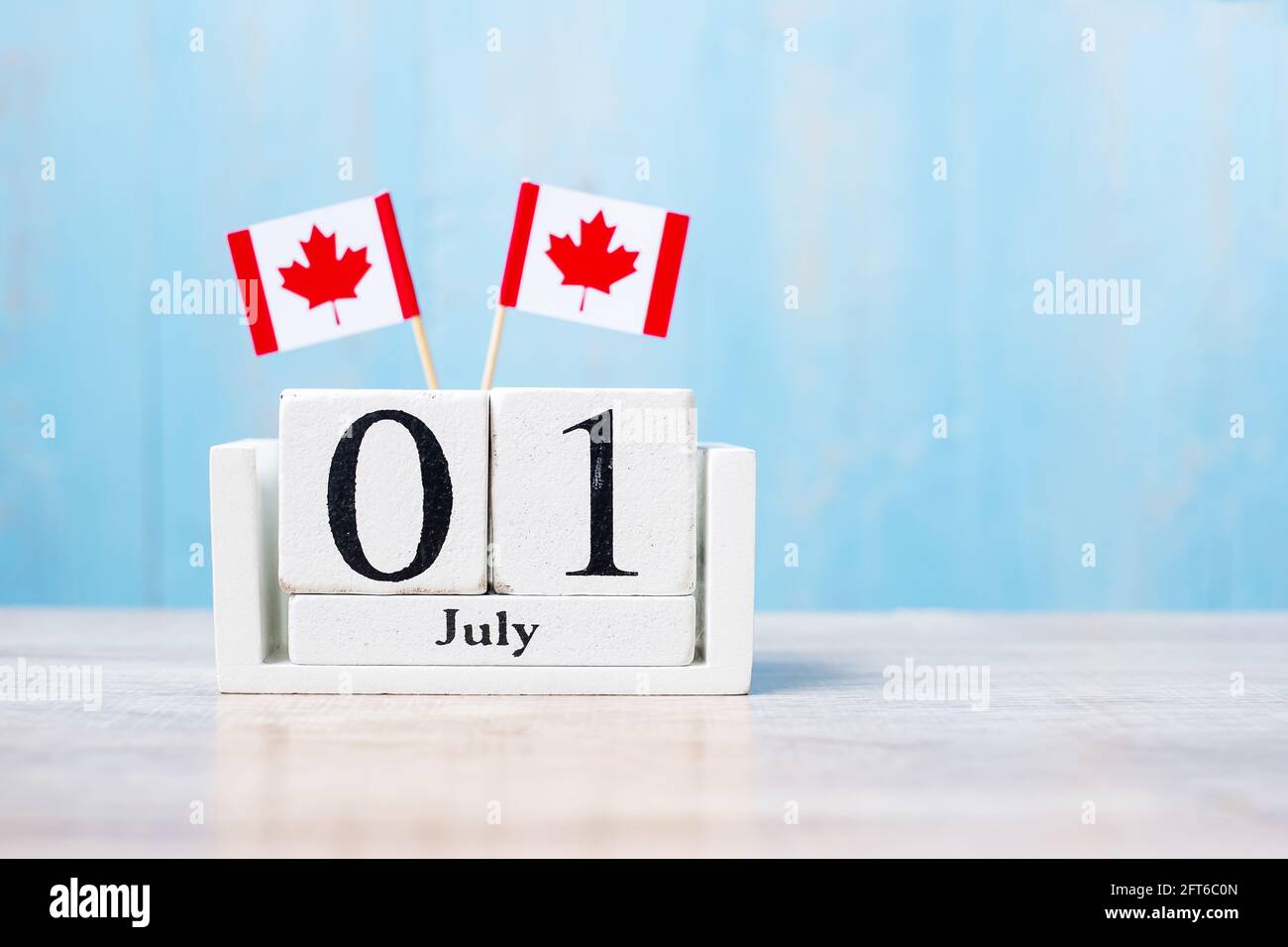 Wooden calendar of July 1st with miniature Canada flags. Canada Day and ...