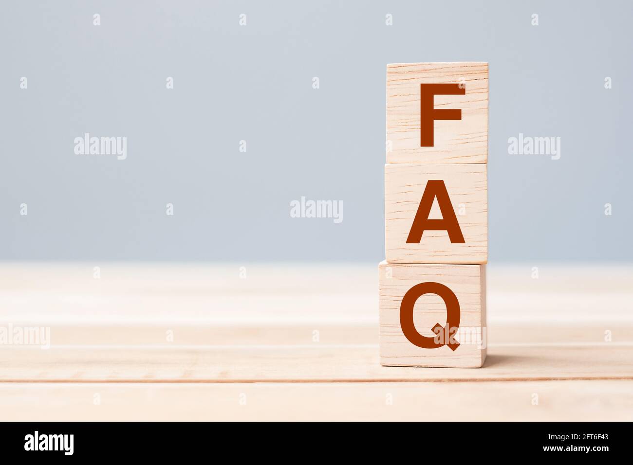 wooden cube blocks with FAQ text (frequently asked questions) on table ...