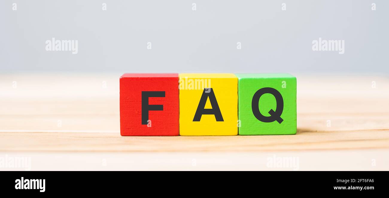 wooden cube blocks with FAQ text (frequently asked questions) on table ...