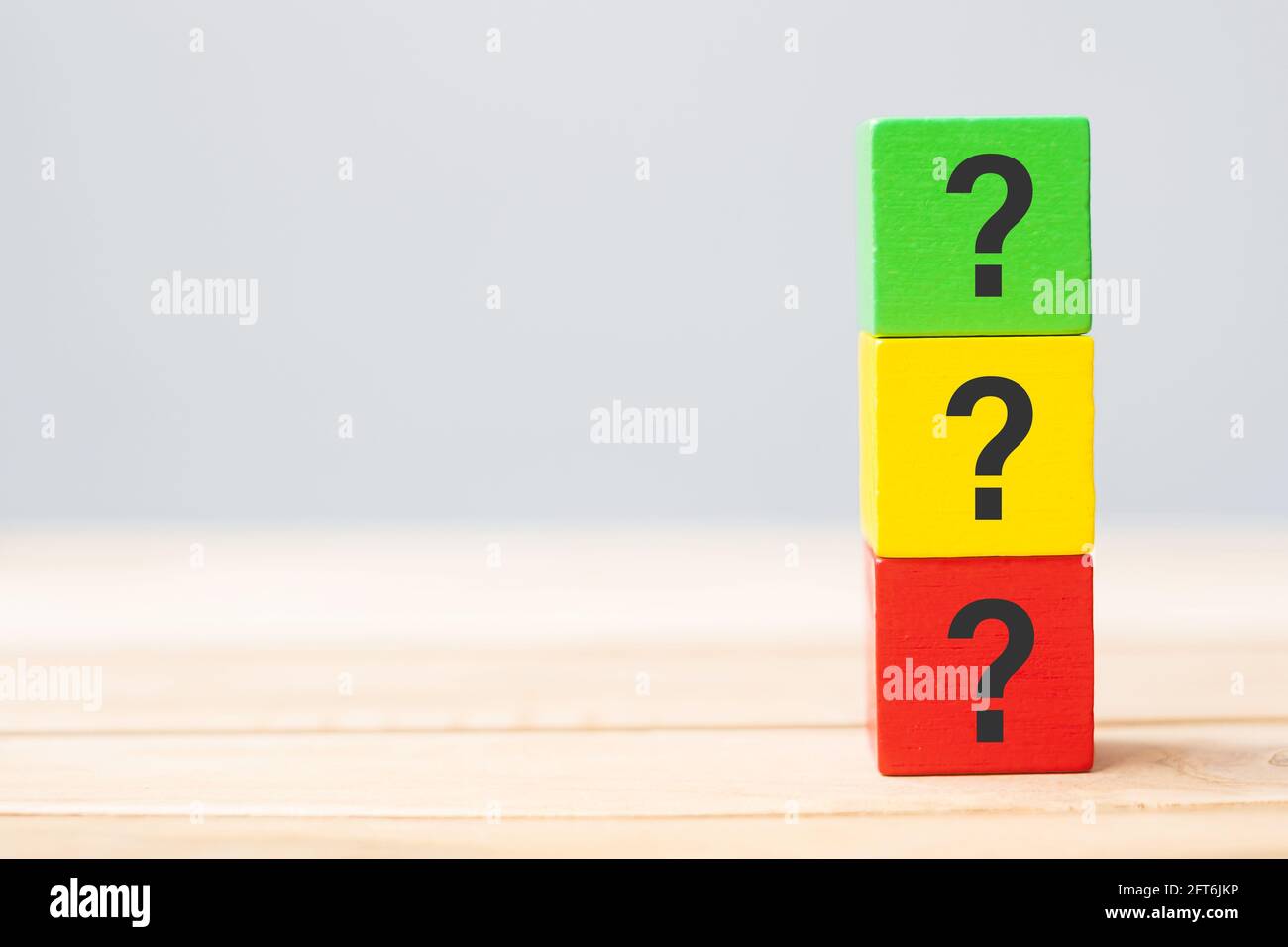 hand holding Questions Mark ( ? ) on wooden cube block on table ...