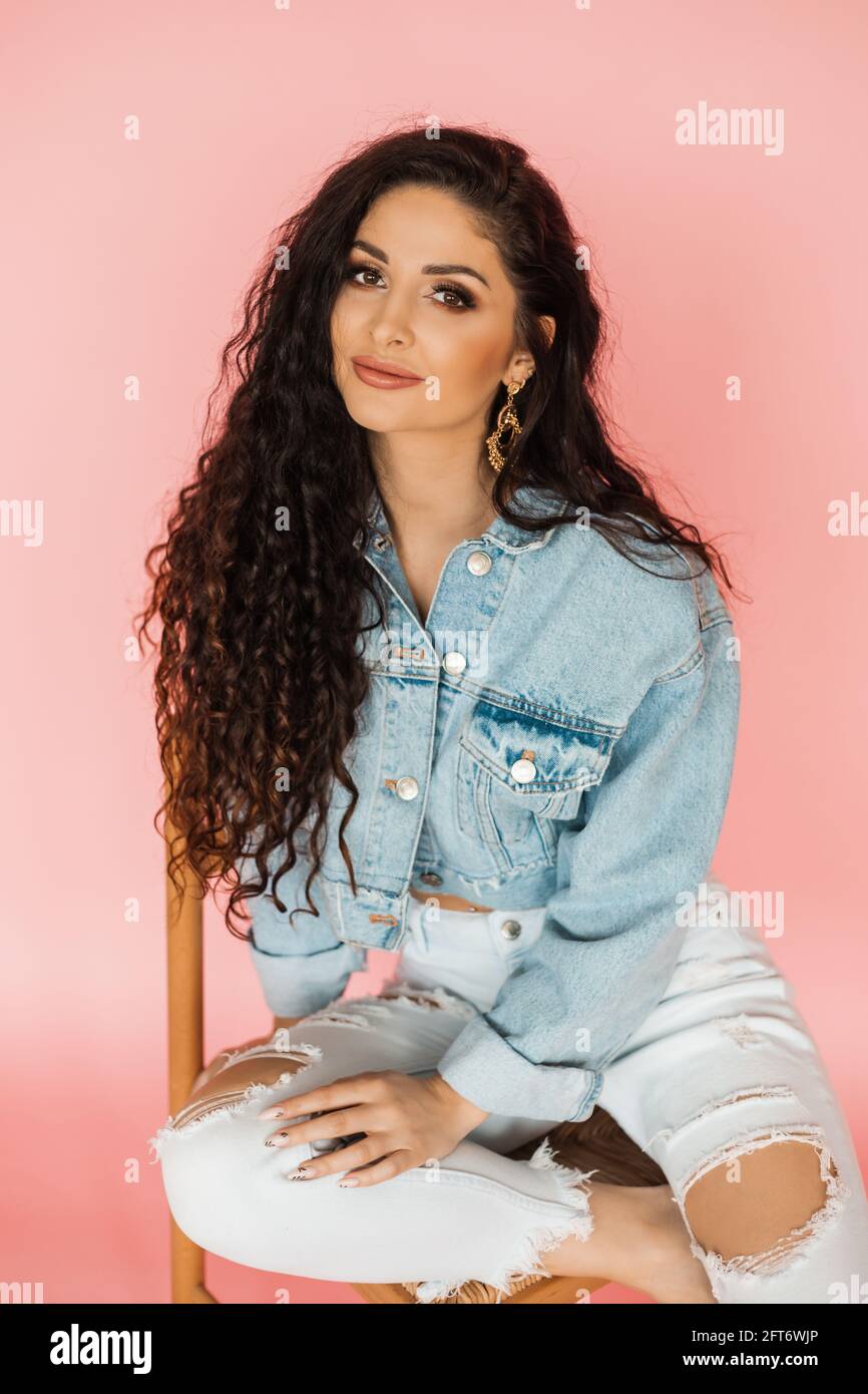 Girl student with beautiful long curly hair looking at camera . online ...