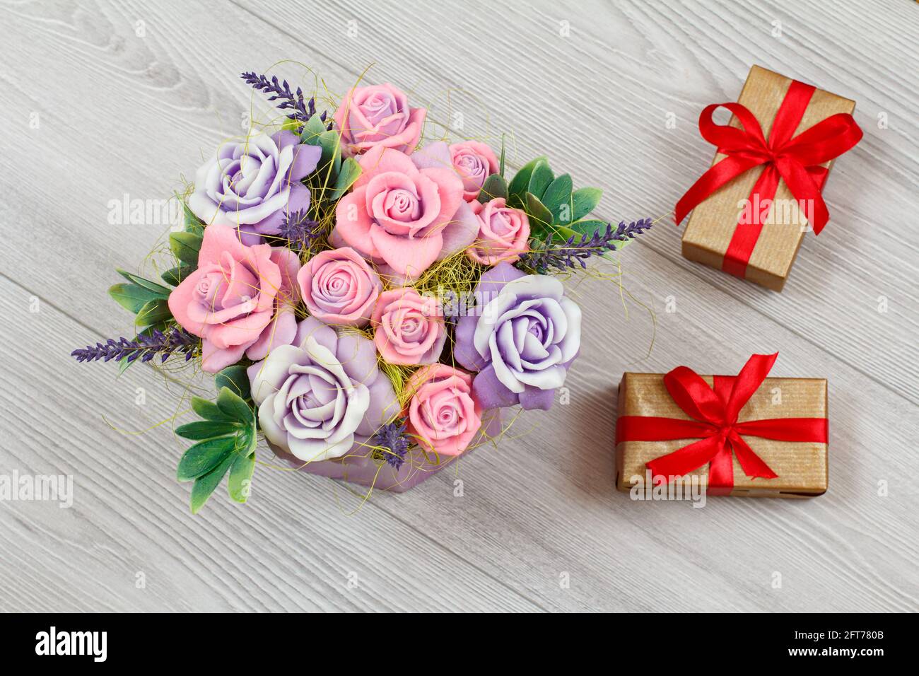 Gift boxes with flowers on the gray background Stock Photo - Alamy