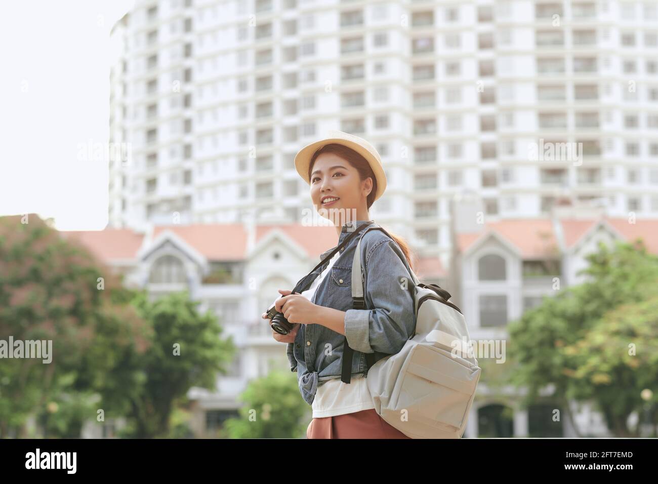 Young beautiful Asian backpack traveler woman using digital compact ...