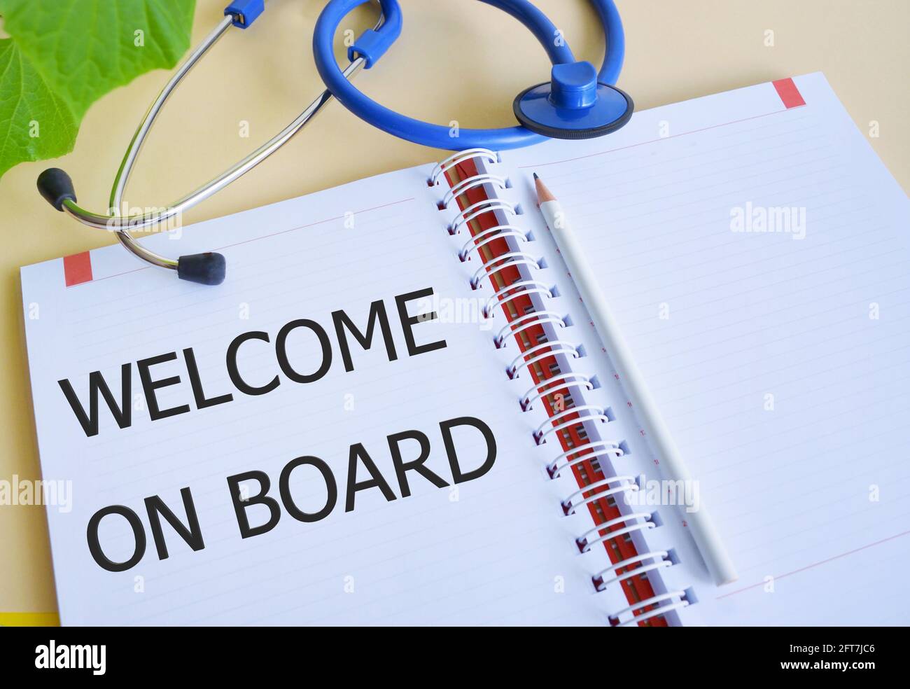 On a beige background, a stethoscope and a white notepad with the ...