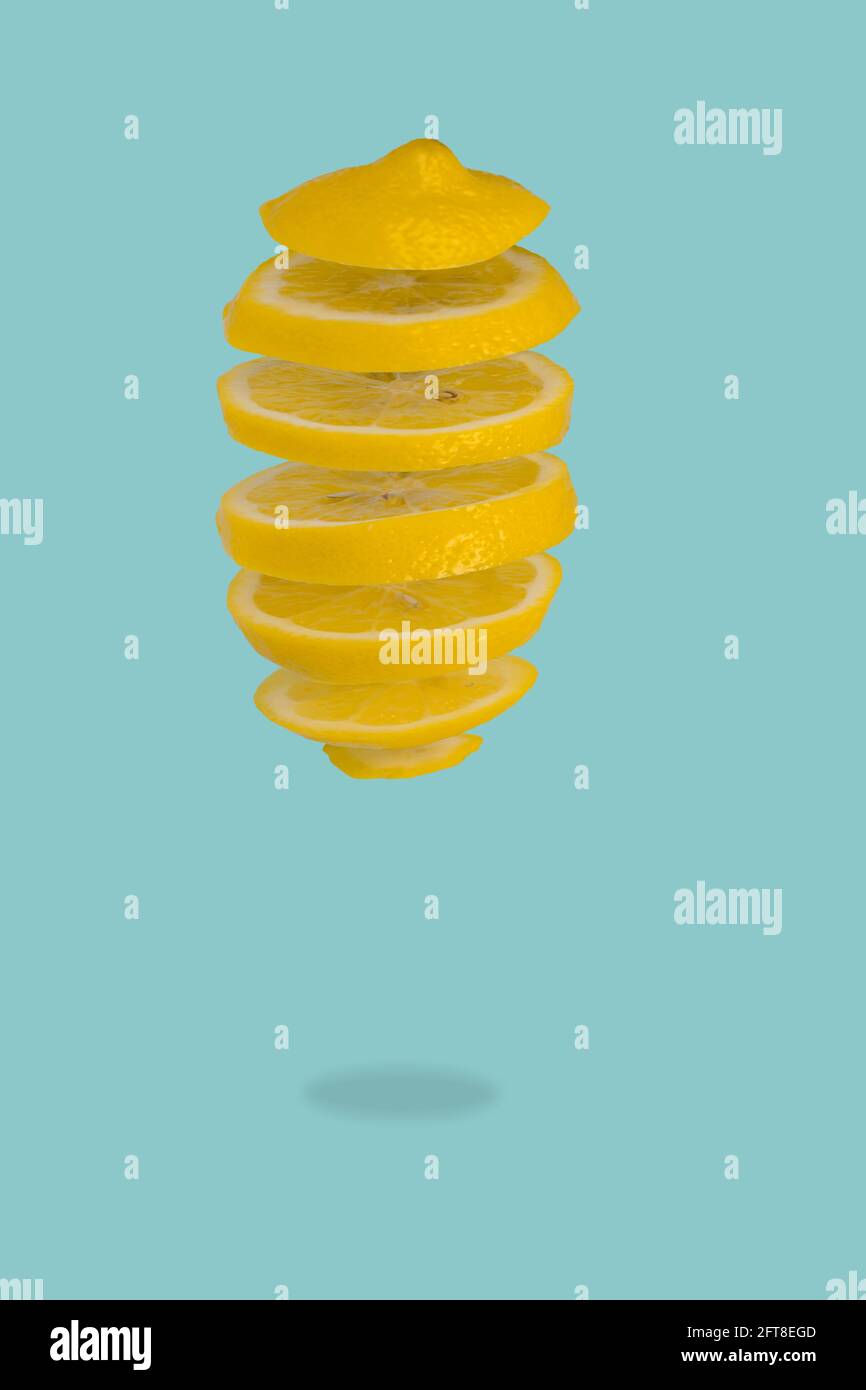 Floating levitating fresh lemon on pastel blue background. Vitamins ...