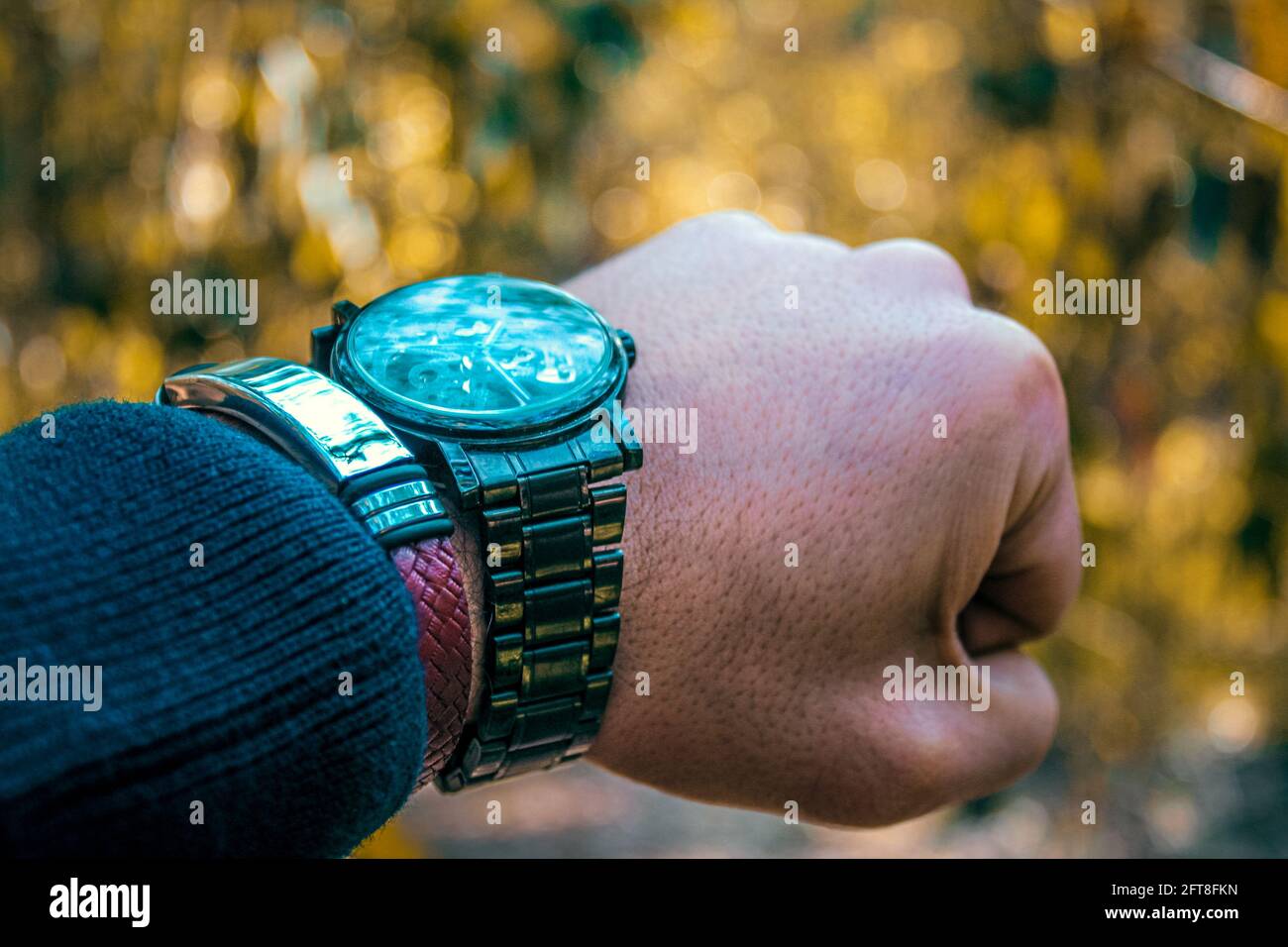big nice and beautiful elegant men's watch on the wrist near the trees ...