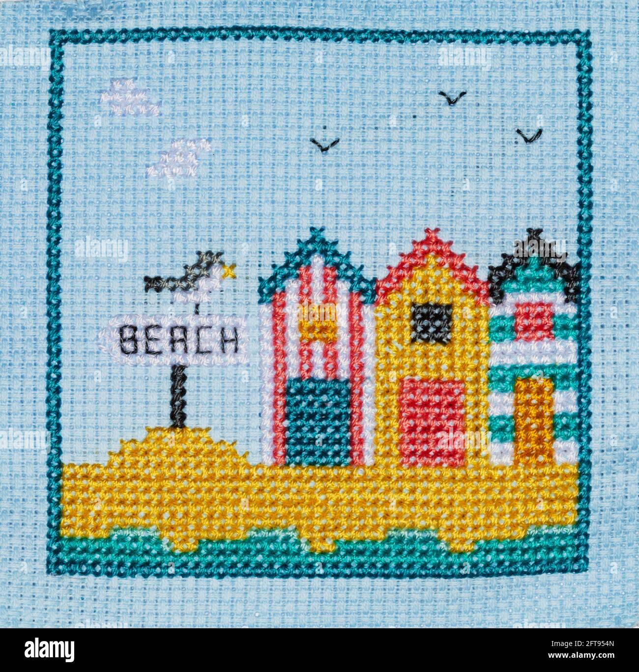 Embroidered needlework picture of the seaside beach huts and beach sign ...