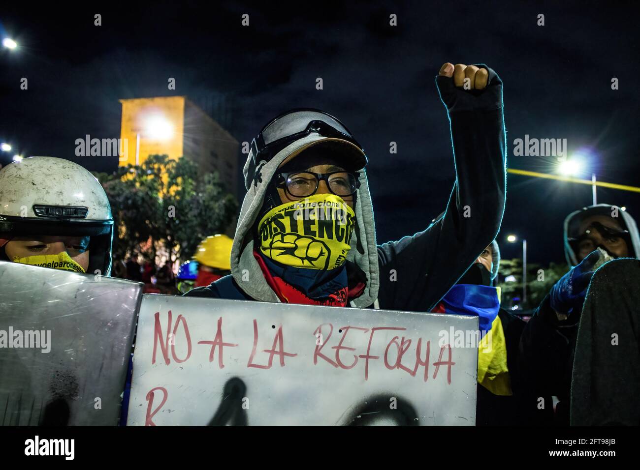 A protester from the first line is seen standing behind their homemade ...
