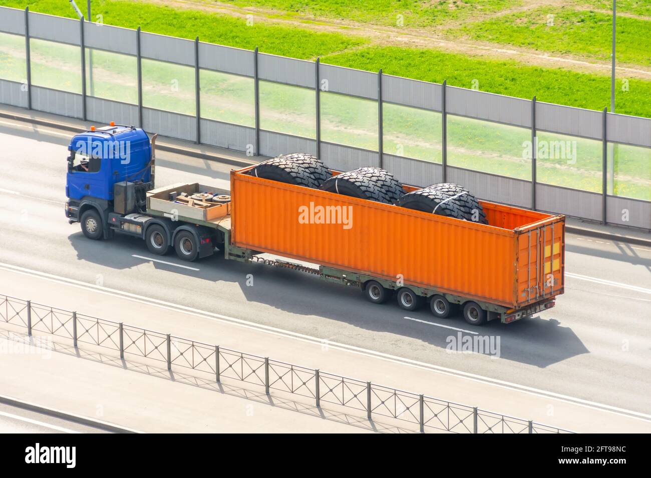 Transporting huge dump truck tire wheels in a container Stock Photo - Alamy
