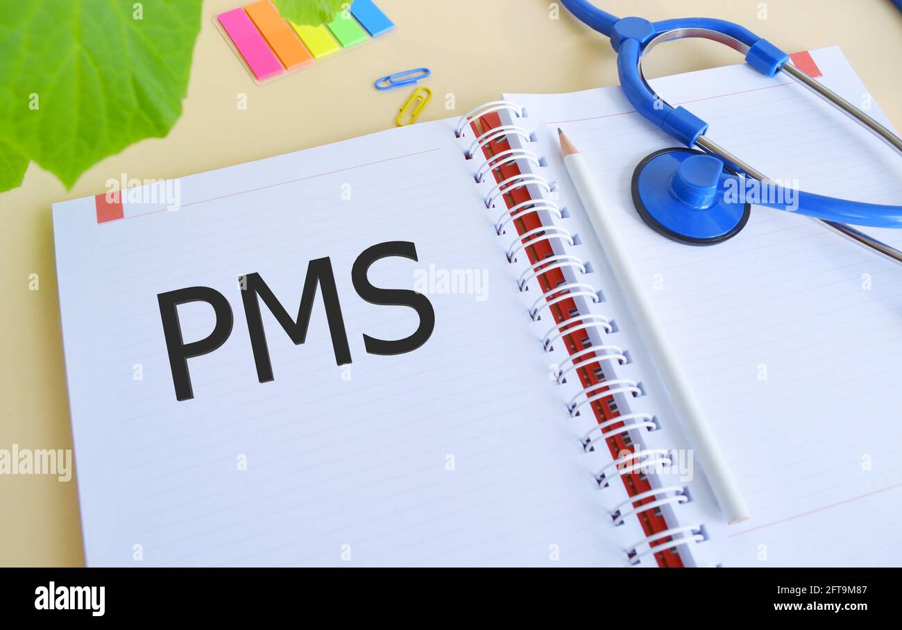 Premenstrual Syndrome PMS text written in Notebook with Stethoscope ...