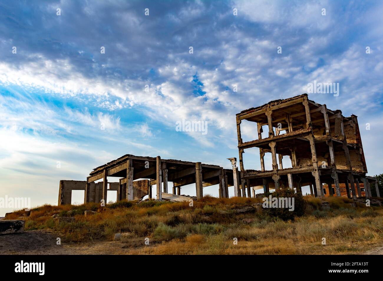 Old abandoned unfinished building damaged by time, wind and rain ...