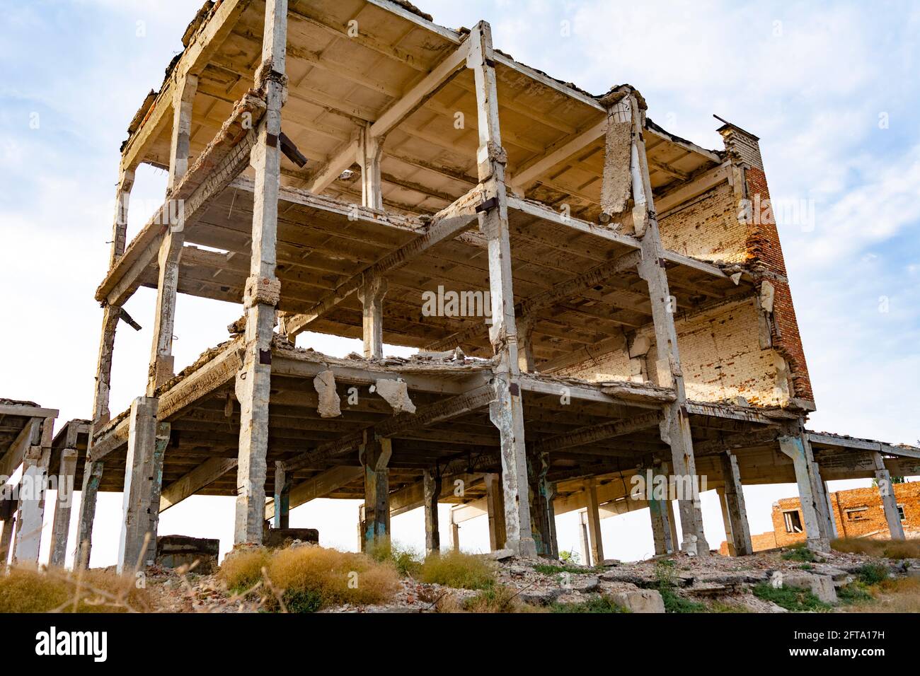 Old abandoned unfinished building damaged by time, wind and rain ...