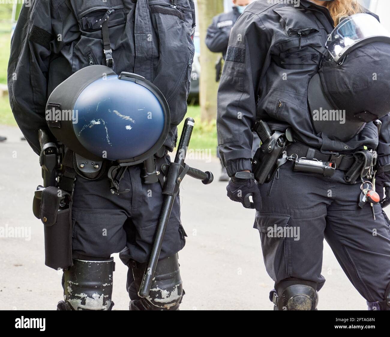 Uniformed German police officers with helmets, batons and knee pads ...