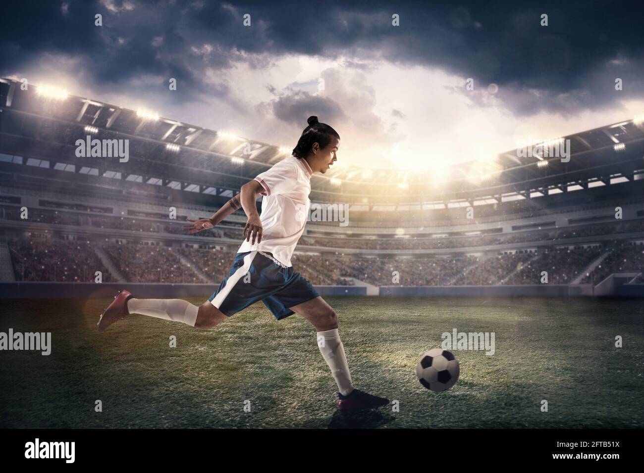 Professional male football, soccer player on stadium background ...