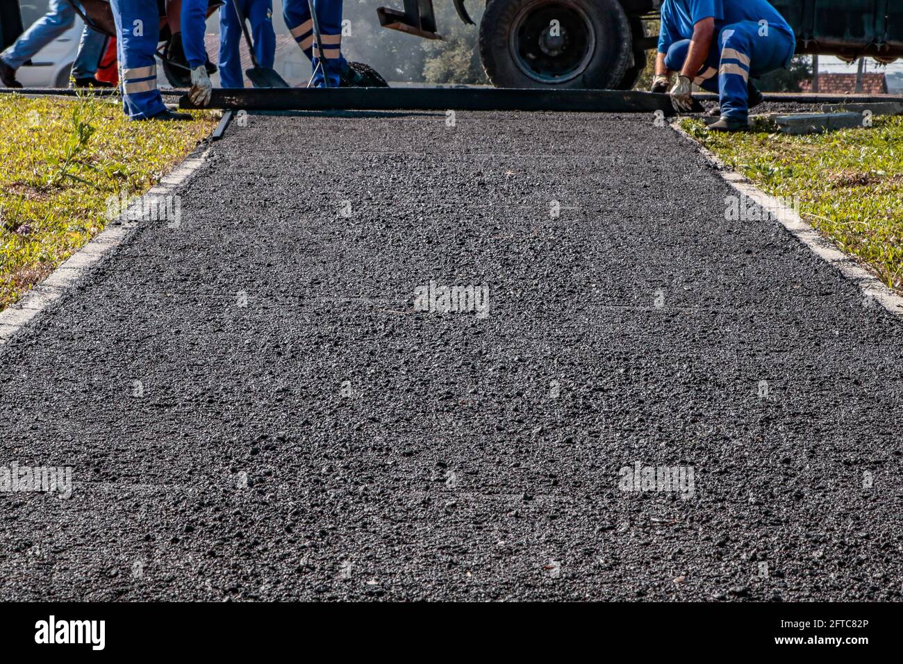 Closed photo of asphalt being applied to the ground, with emphasis on ...