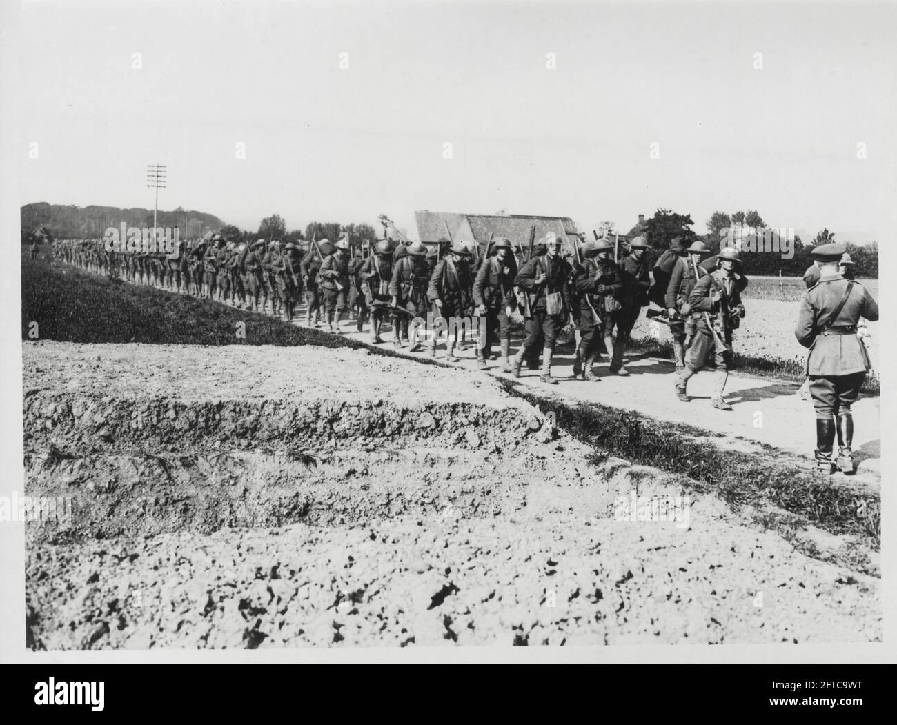 World War One, WWI, Western Front - American troops march along a road ...