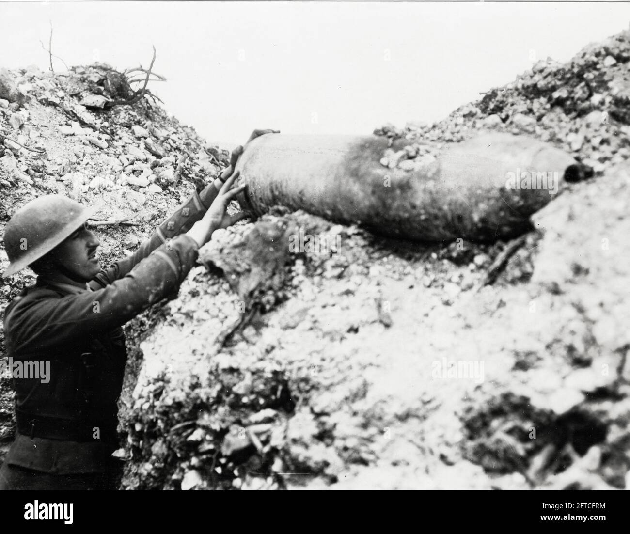 World War One, WWI, Western Front - A soldier handles a German 'dud ...