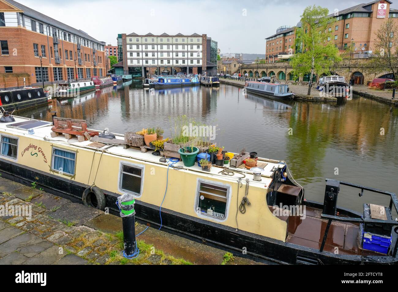 The canal basin in central Sheffield with colourful barges and water ...