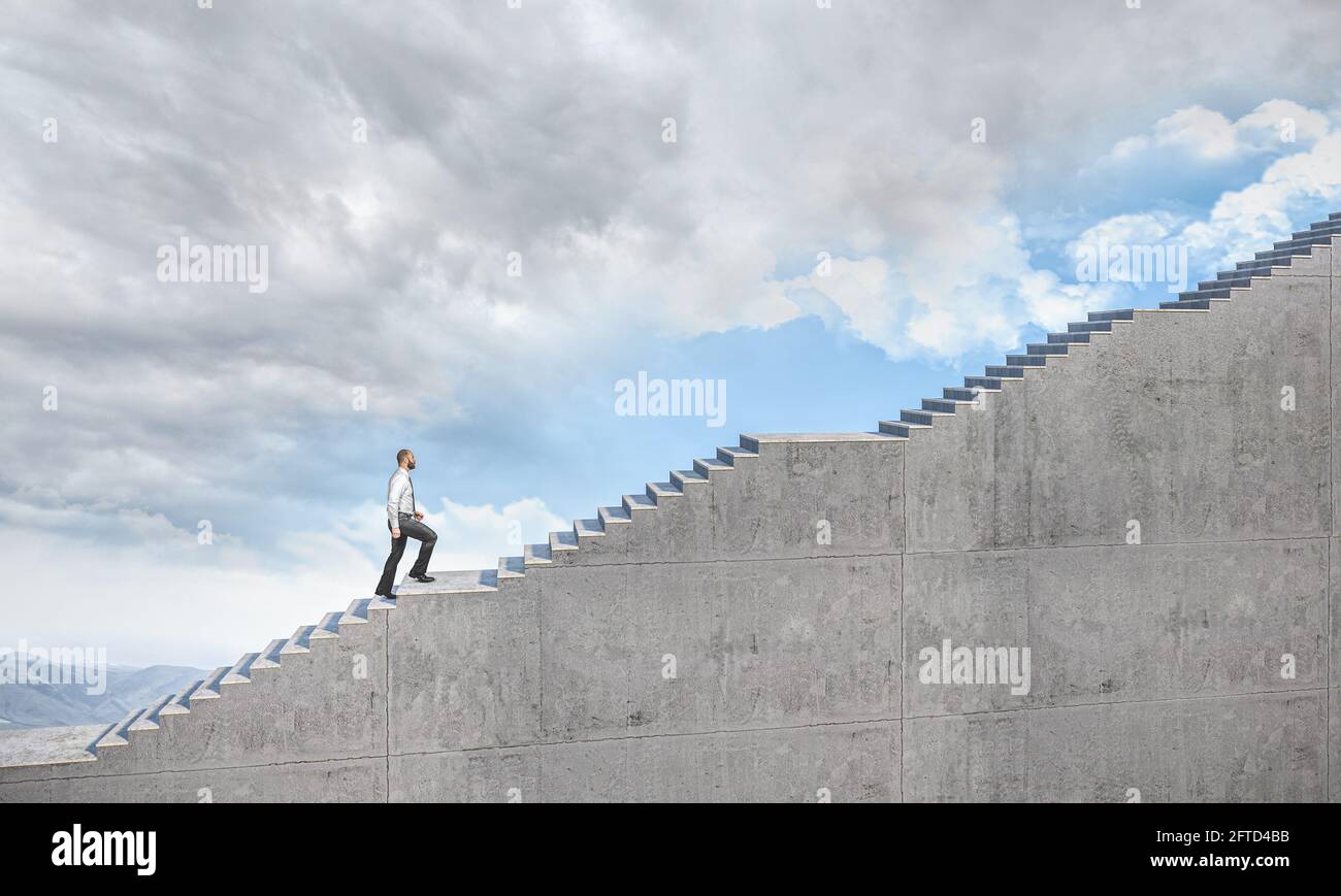 businessman climbing a long ladder leading to the sky. concept of ...
