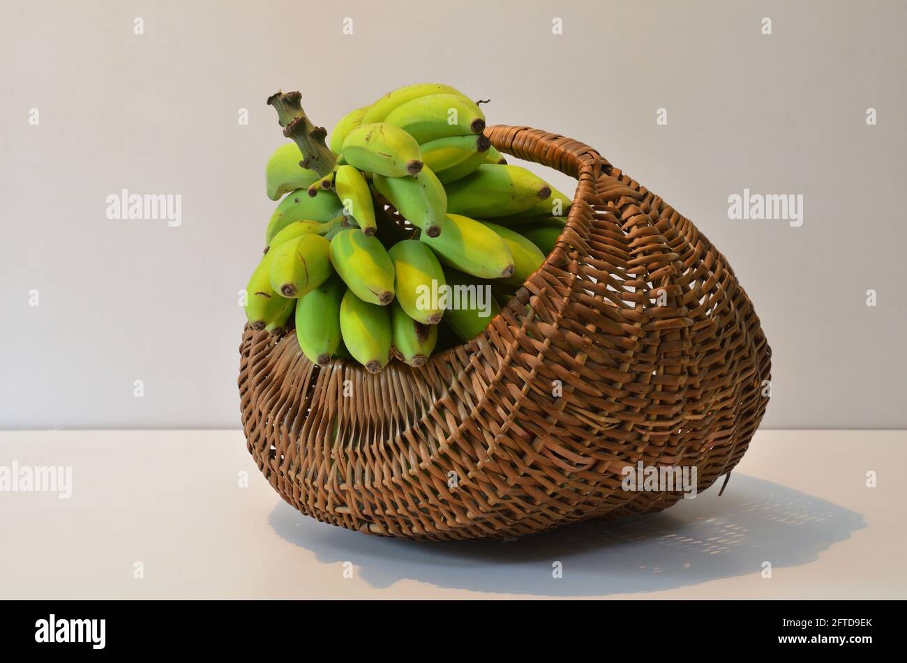 Raw bananas in a basket Stock Photo - Alamy