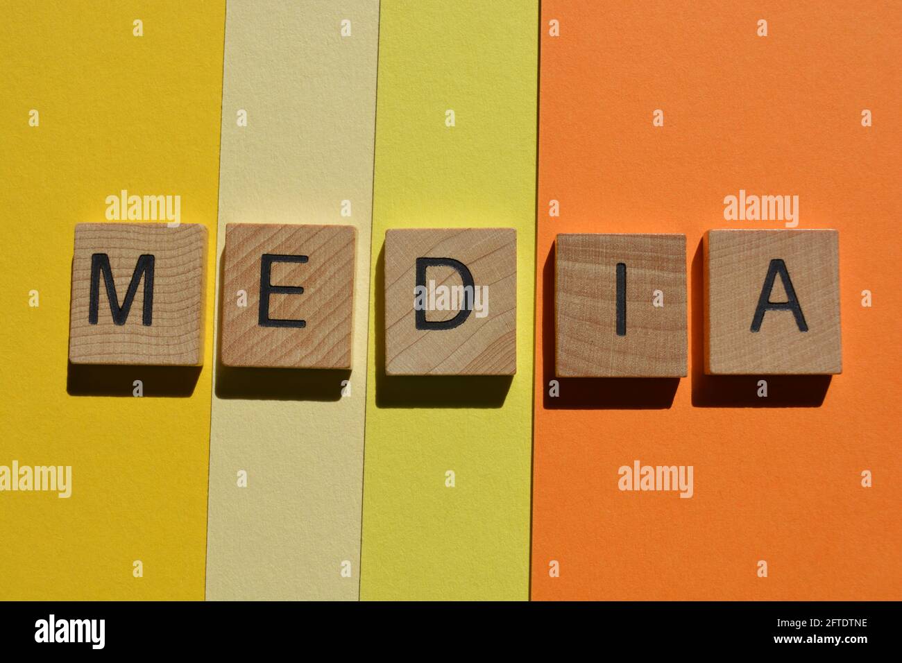 Media, word in wooden alphabet letters isolated on colourful background ...