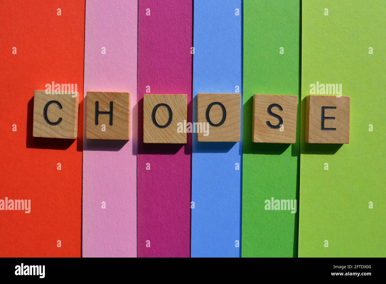 Choose, word in wooden alphabet letters isolated on colorful background ...