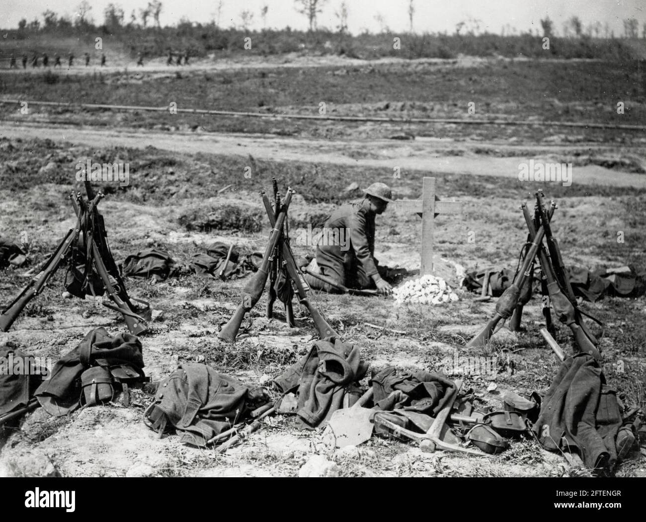 World War One, WWI, Western Front - Man tidying the grave of a fallen ...