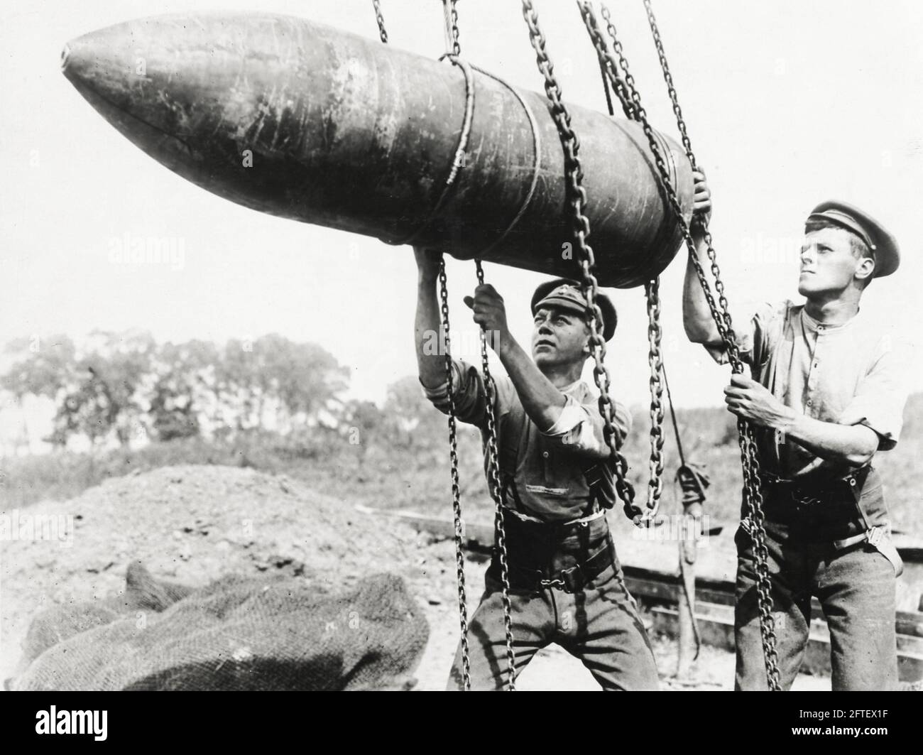 World War One, WWI, Western Front - Two men manoeuvring a large shell ...