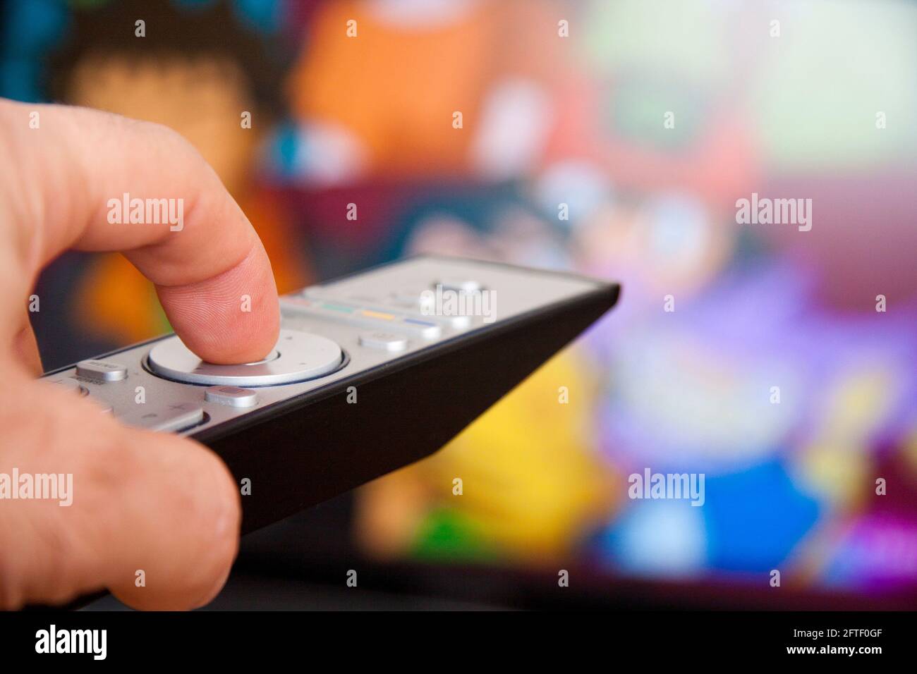 hand on the tv remote channel changing Stock Photo - Alamy