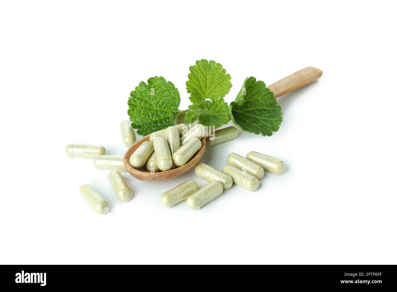 Spoon with herbal powder capsules isolated on white background Stock ...