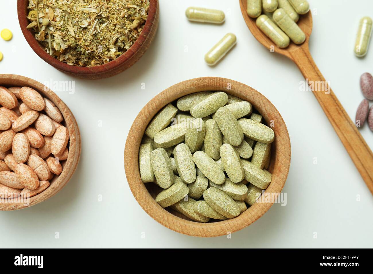 Concept of herbal medicine pills on white background Stock Photo - Alamy