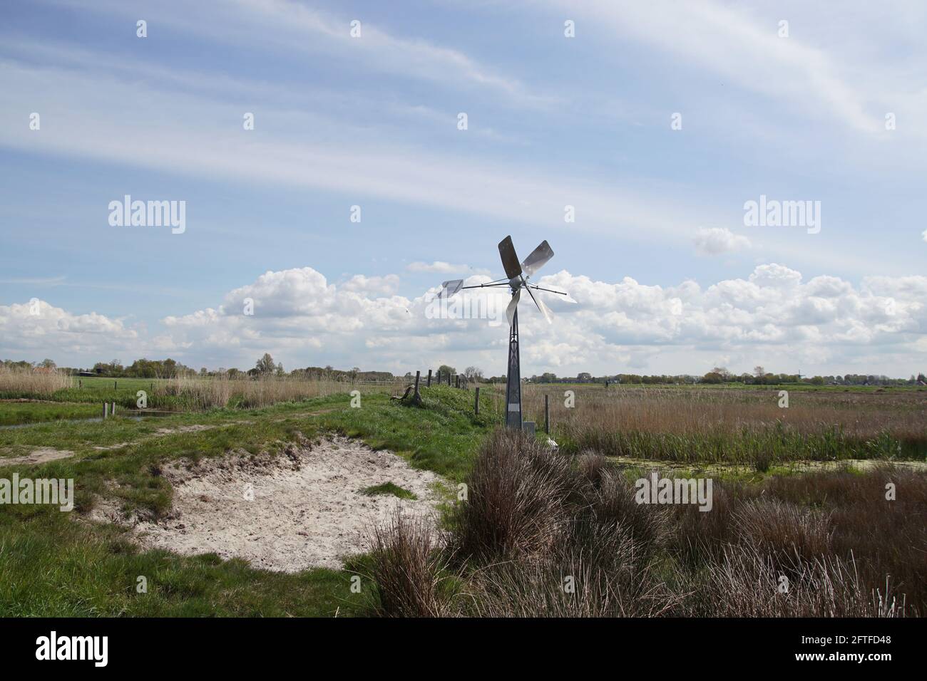 Small,Dutch metal windmill with a wind vane that pumps water. Called ...