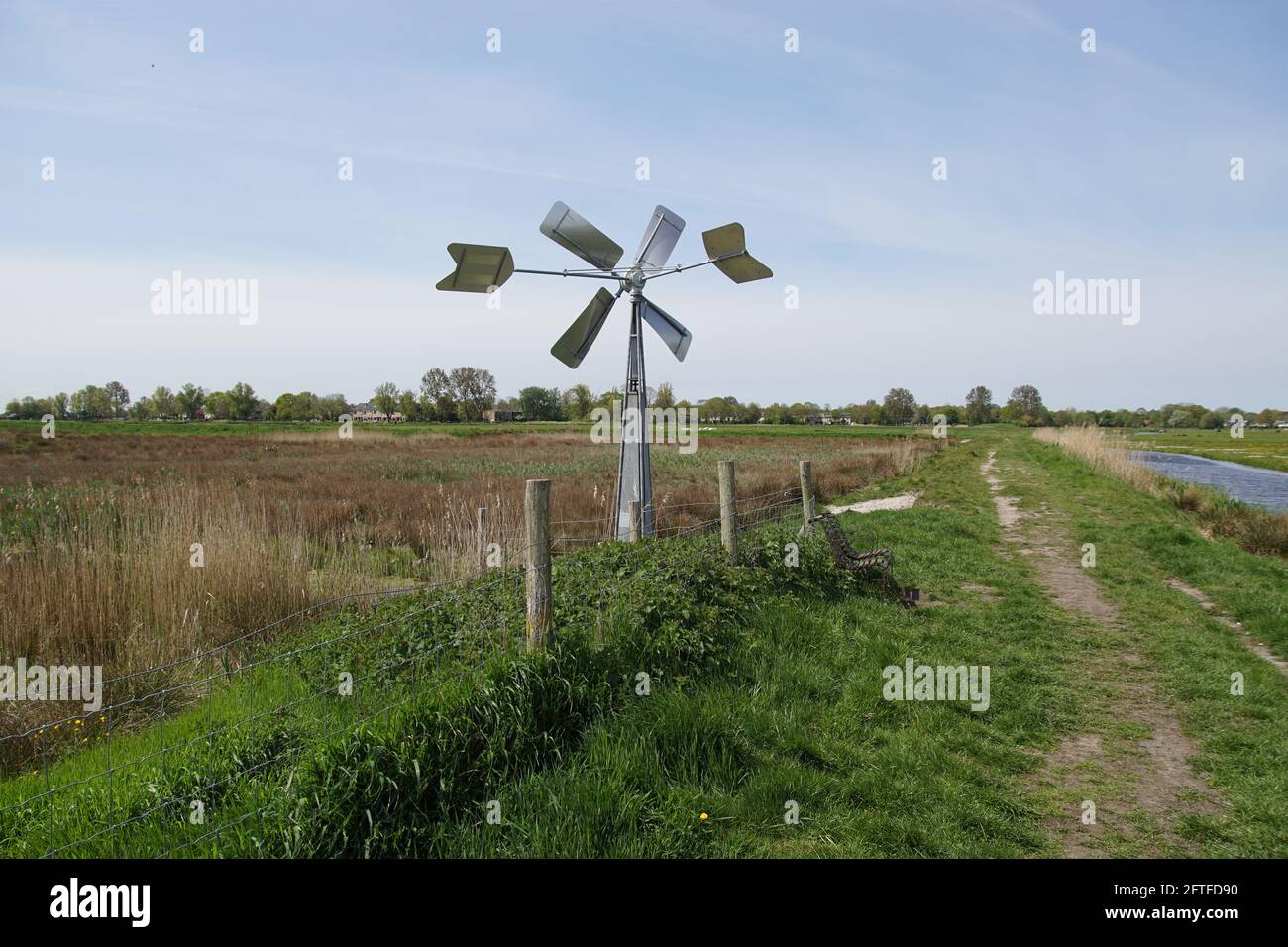 Small,Dutch metal windmill with a wind vane that pumps water. Called ...