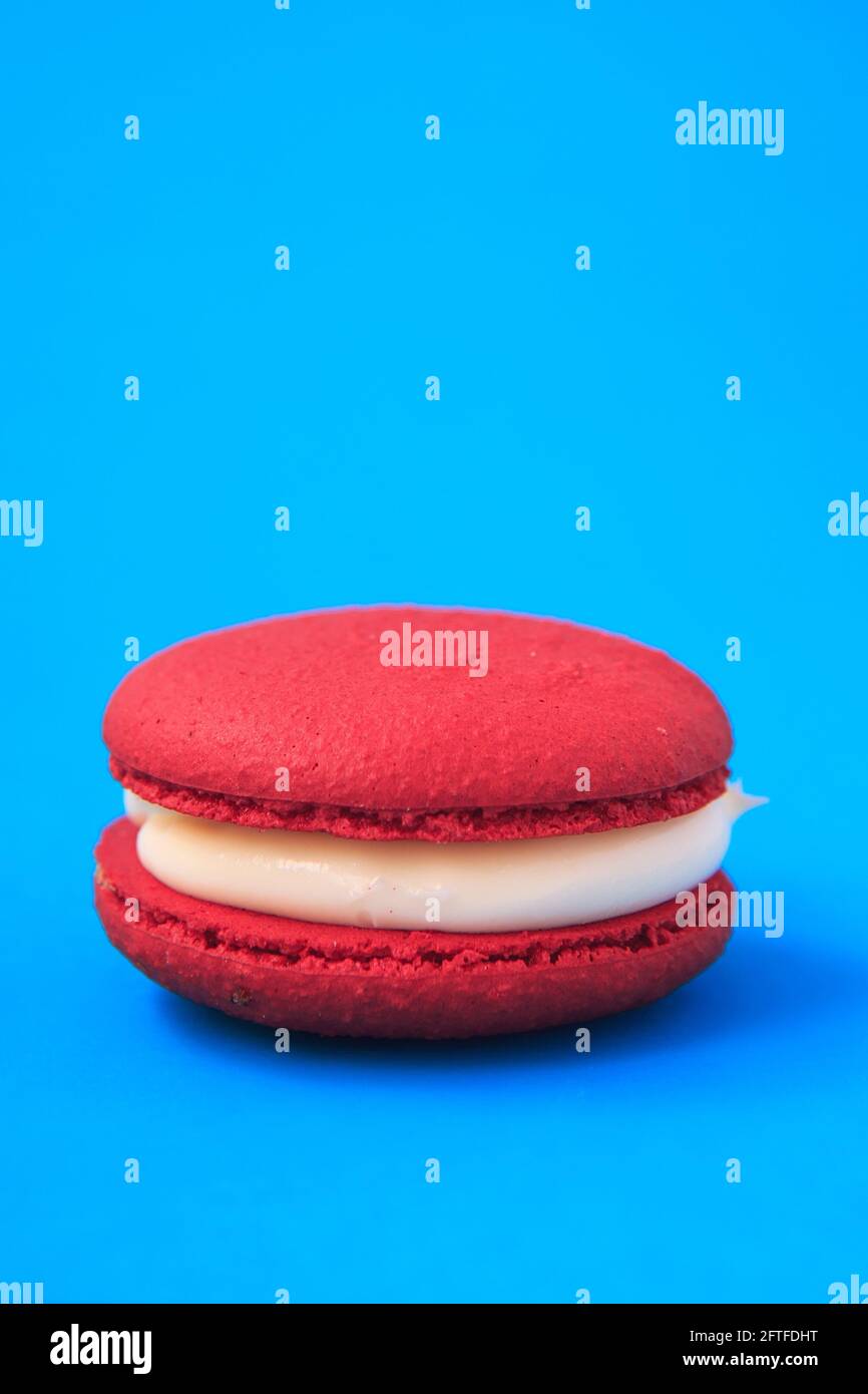 red Cake macaron or macaroon on blue background. colorful almond ...