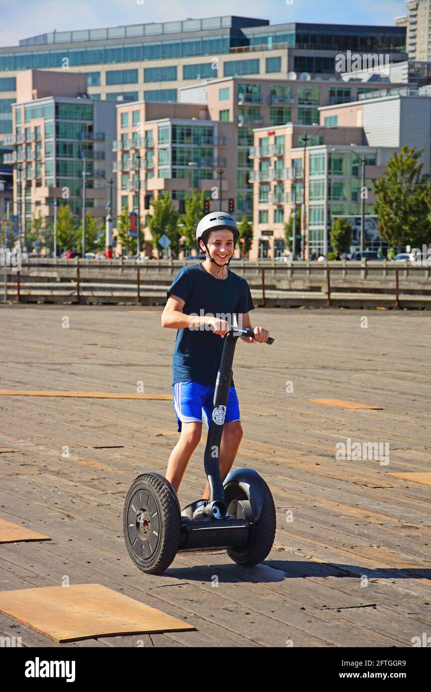 Young kid enjoy a segway ride Stock Photo - Alamy