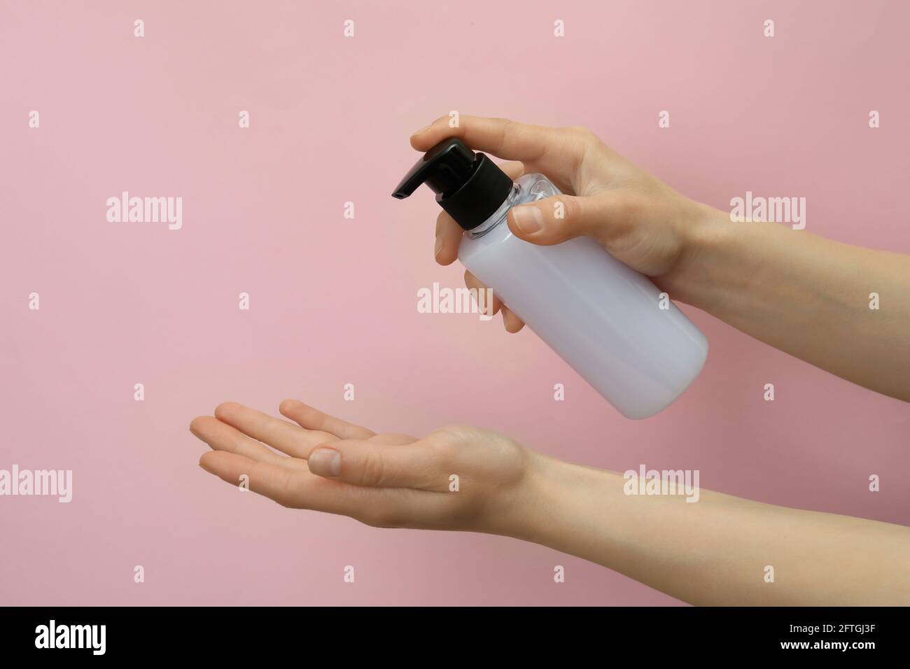 Female hands apply shower gel on pink background Stock Photo - Alamy