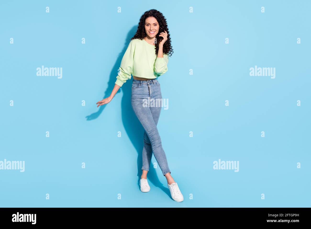 Photo of coquettish lovely lady beaming smile palm hair wear pullover ...