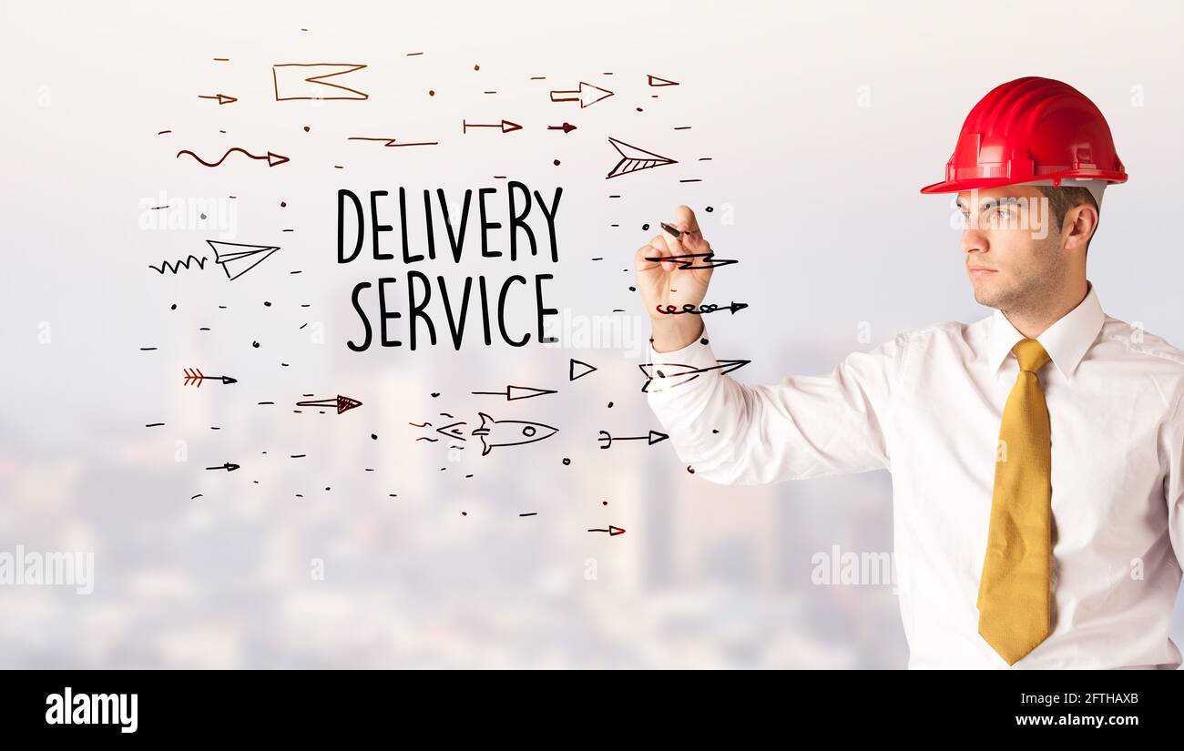 Young businessman with helmet drawing sale sign Stock Photo - Alamy
